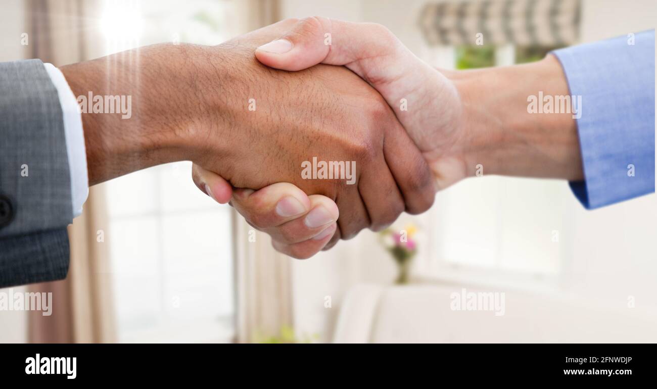 Composition of businessmen shaking hands on grey background Stock Photo ...