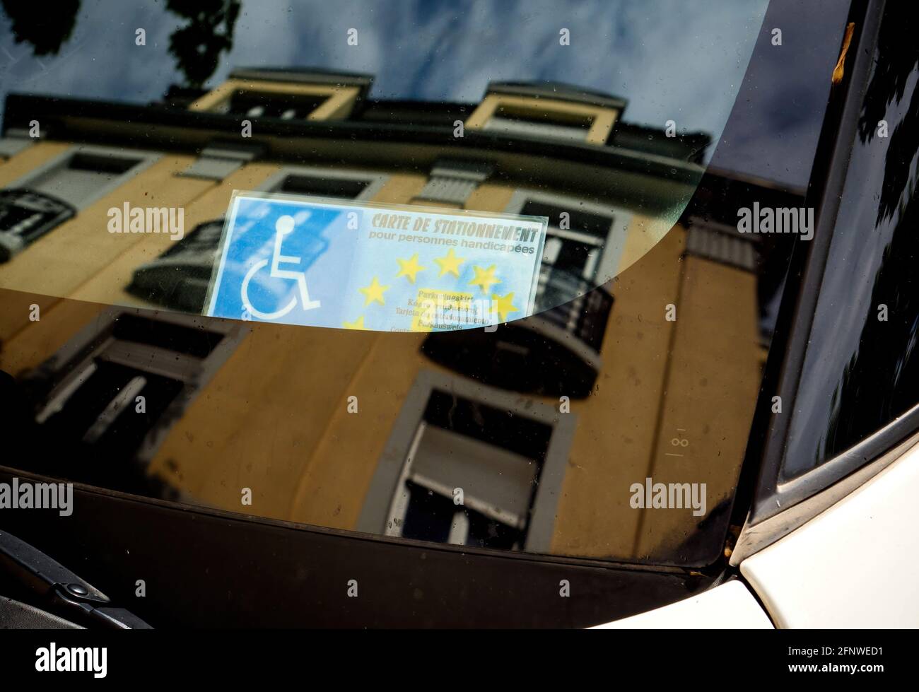 Parking card for disabled people on the card windshield reflection of ...