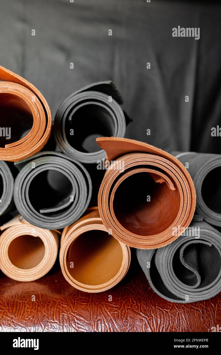 Vertical closeup of brown and black textile genuine leather rolls Stock ...