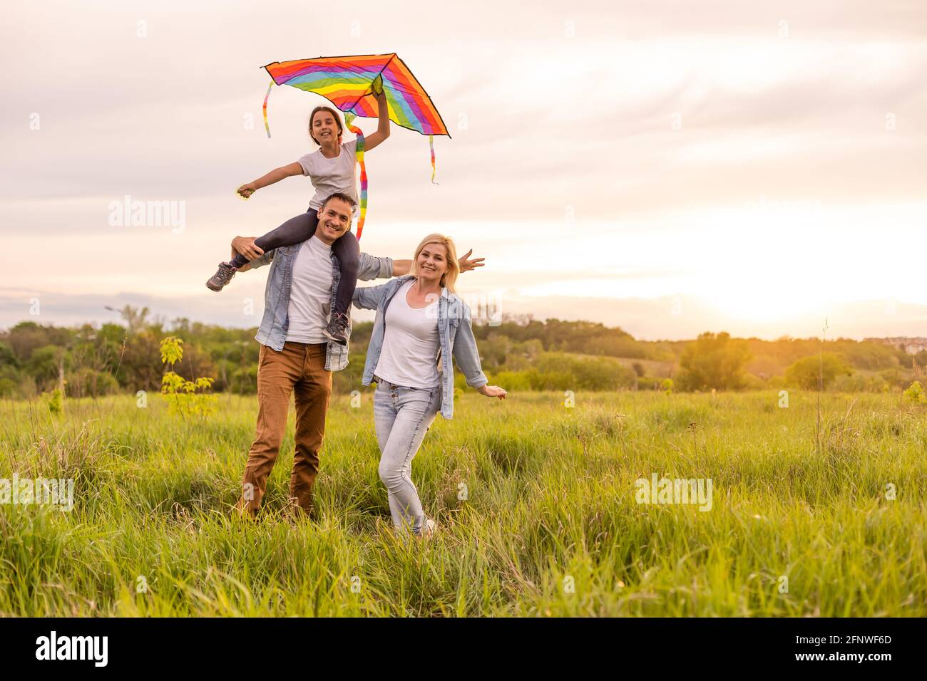 Happy family: mother, father, child daughter on nature on sunset Stock ...