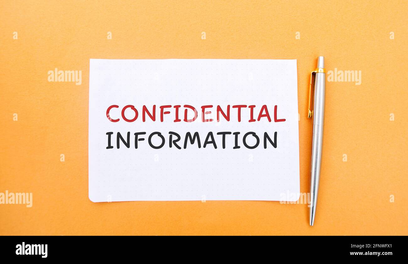 Notes with the inscription Confidential information and a pen. Non ...