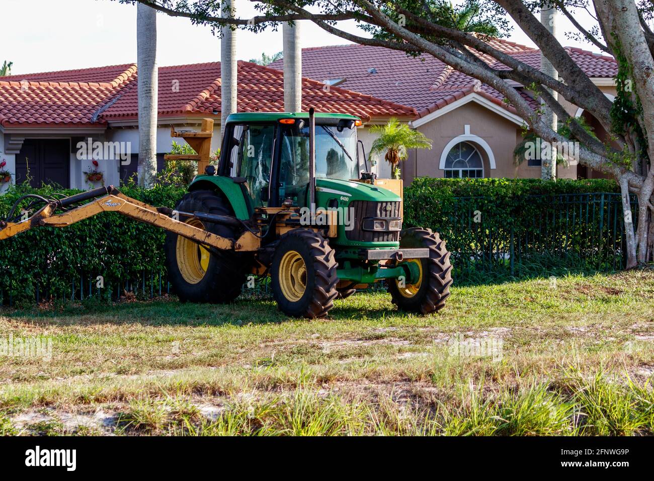 John Deere 6430 Tractor with a long boom for cutting and mowing and ... John Deere 6430 Tractor with a long boom for cutting and mowing and ...