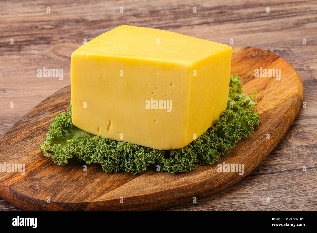 Yellow tilsiter cheese dairy product brick Stock Photo - Alamy