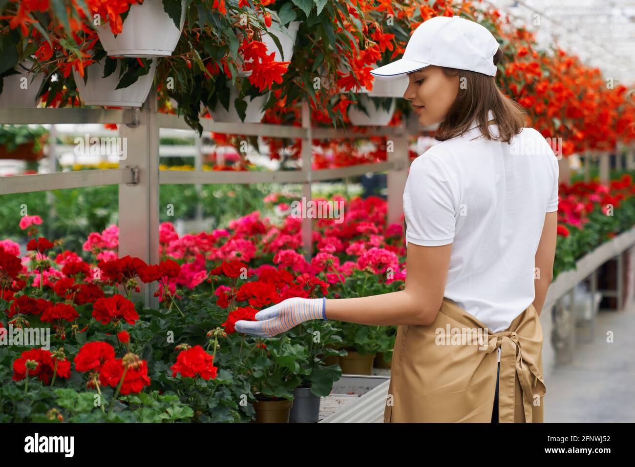 Side view of beautiful young woman in white gloves and special uniform ...