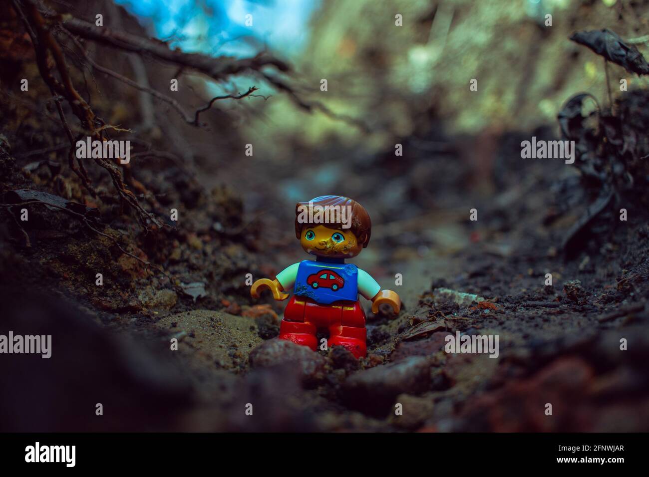 damaged toy boy figurine in red and blue with car sign on the chest ...