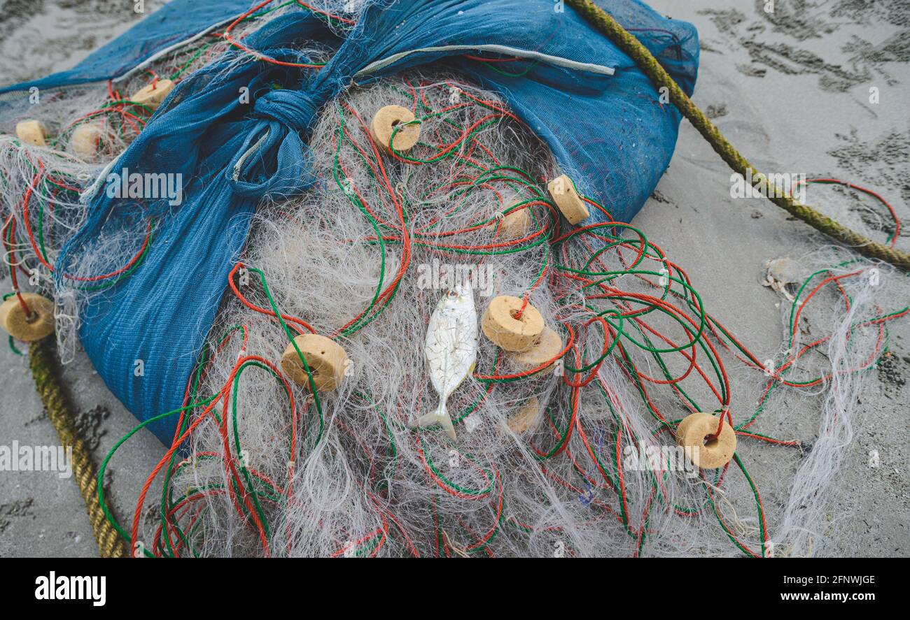 Fishing net on the beach with outdoor low lighting Stock Photo - Alamy