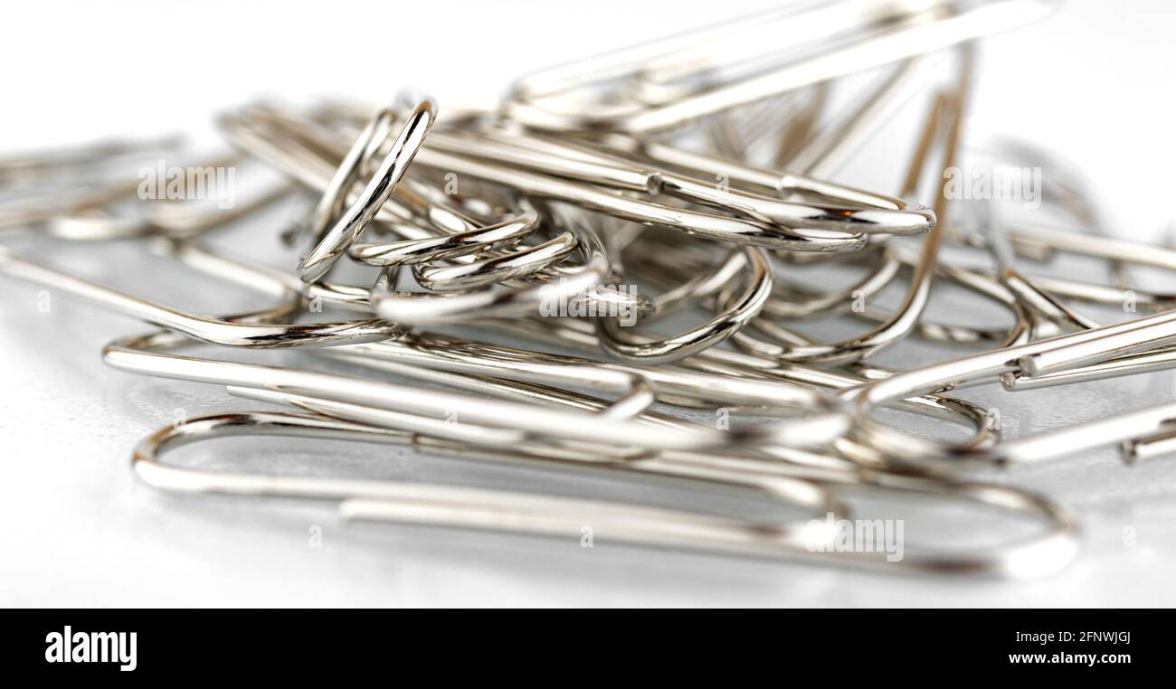 Bunch of steel metal paper clips on white background Stock Photo - Alamy