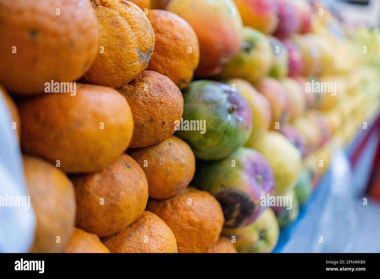 Close-up of a colorful fruit stand with tangerines and mangoes Stock ...