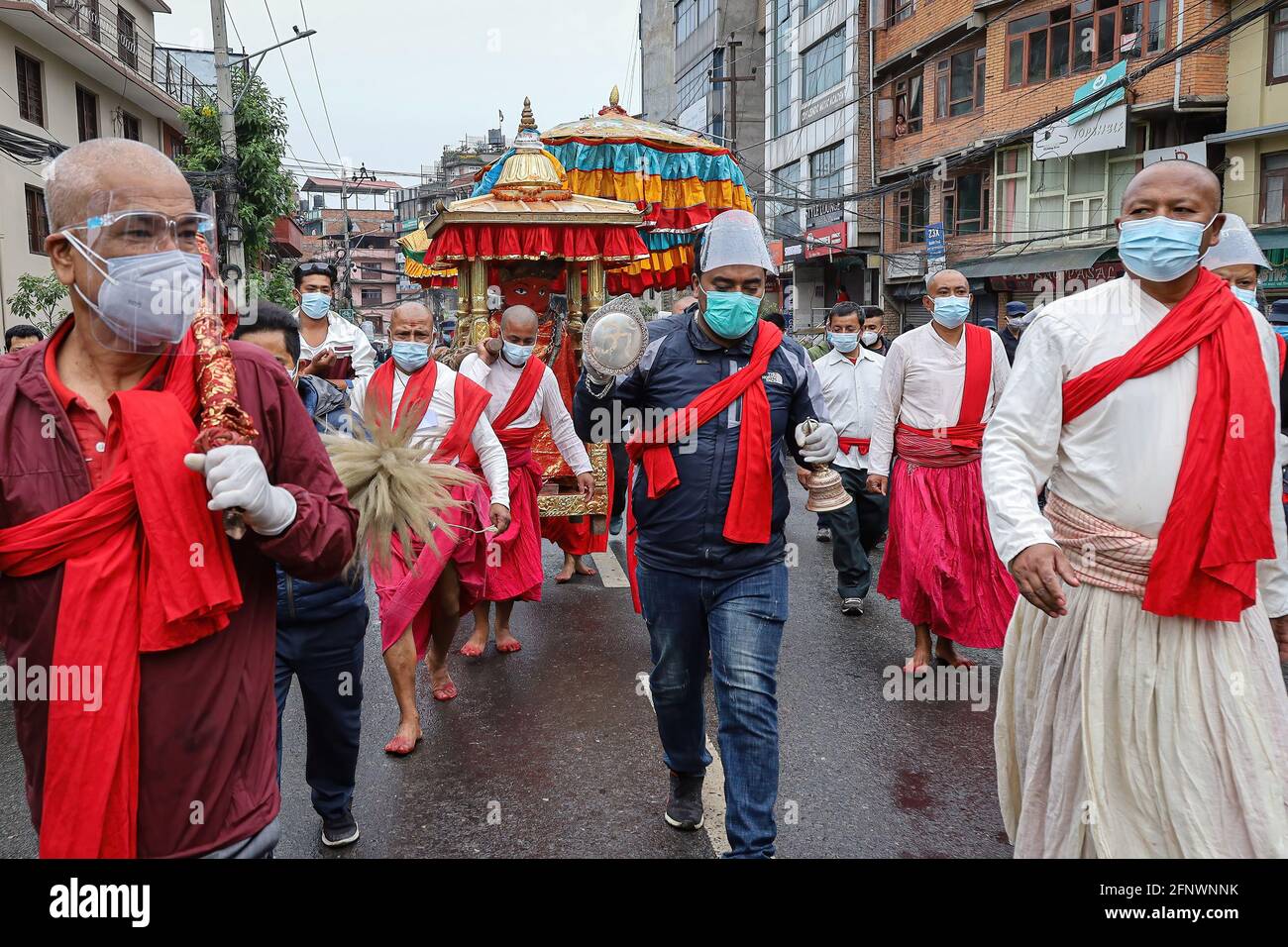 Lalitpur, Nepal. 19th May, 2021. Nepalese devotees carry an idol of ...