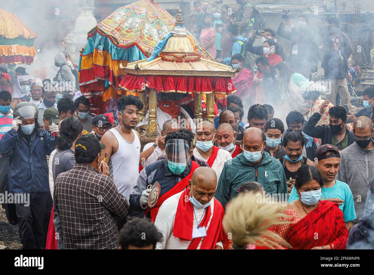 Lalitpur, Nepal. 19th May, 2021. Nepalese devotees carry an idol of ...