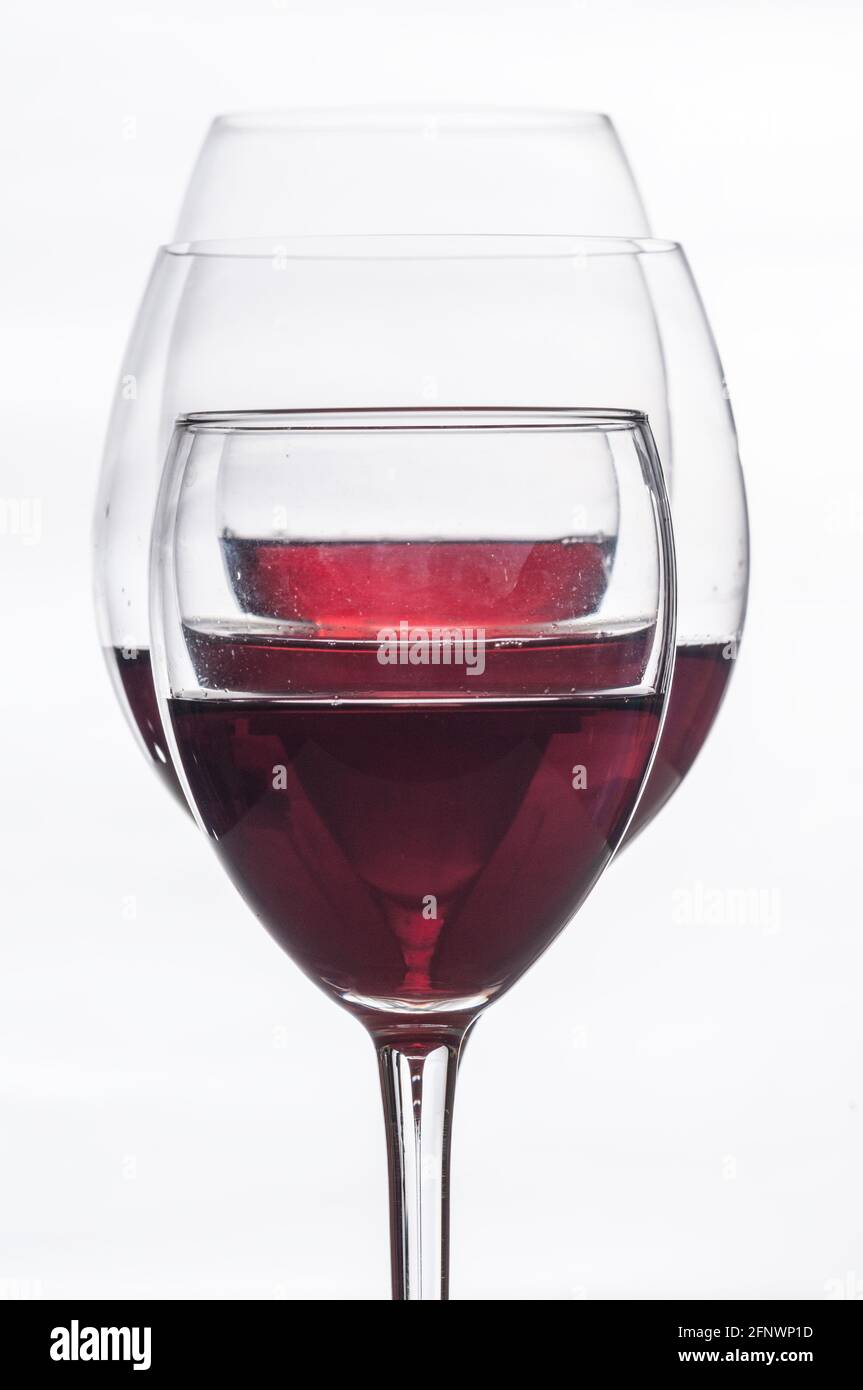 Vertical shot of crystal glasses with red wine isolated on white ...
