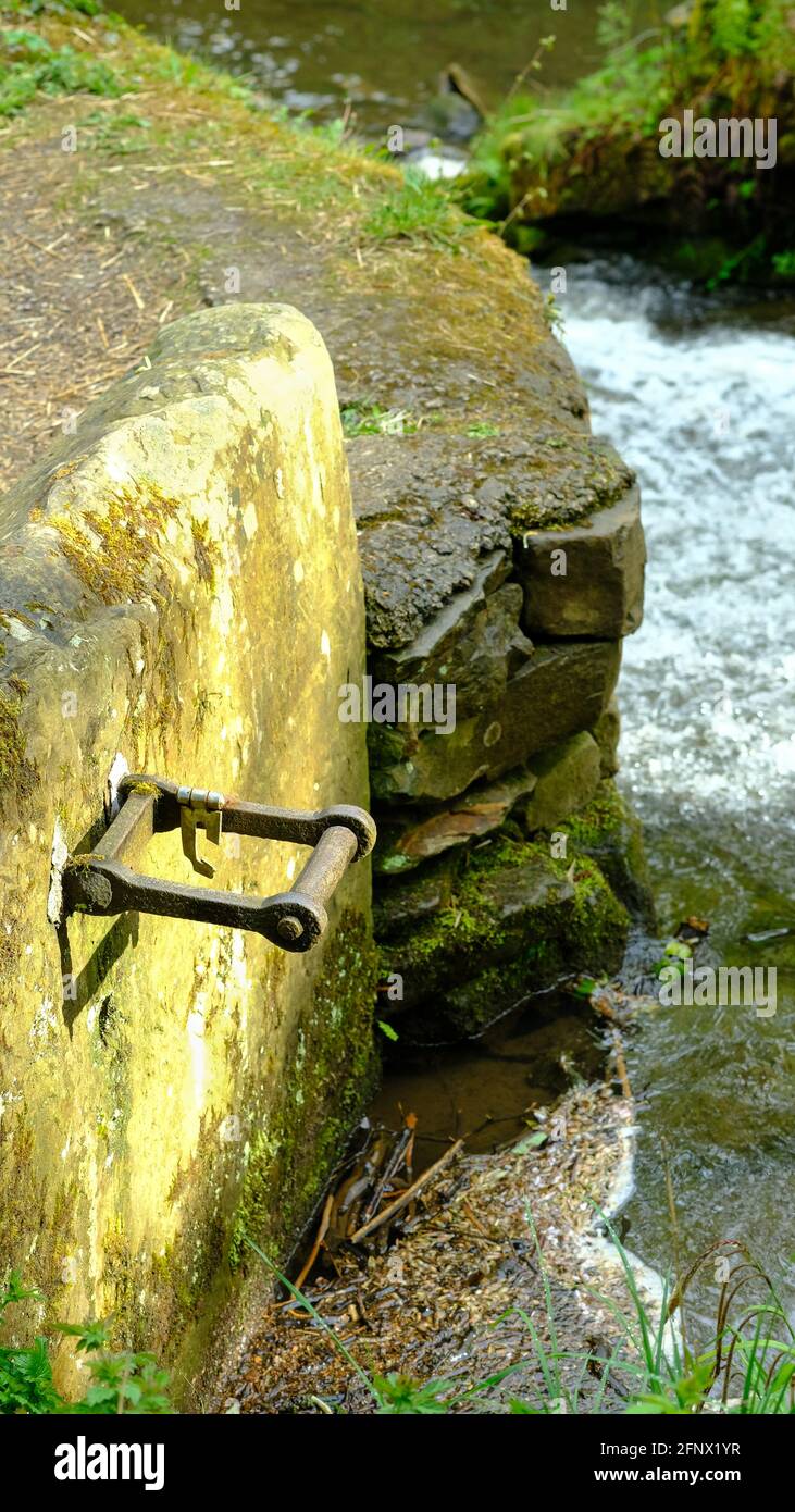 A mysterious iron fixing attached to the stone walling of Porter Brook ...