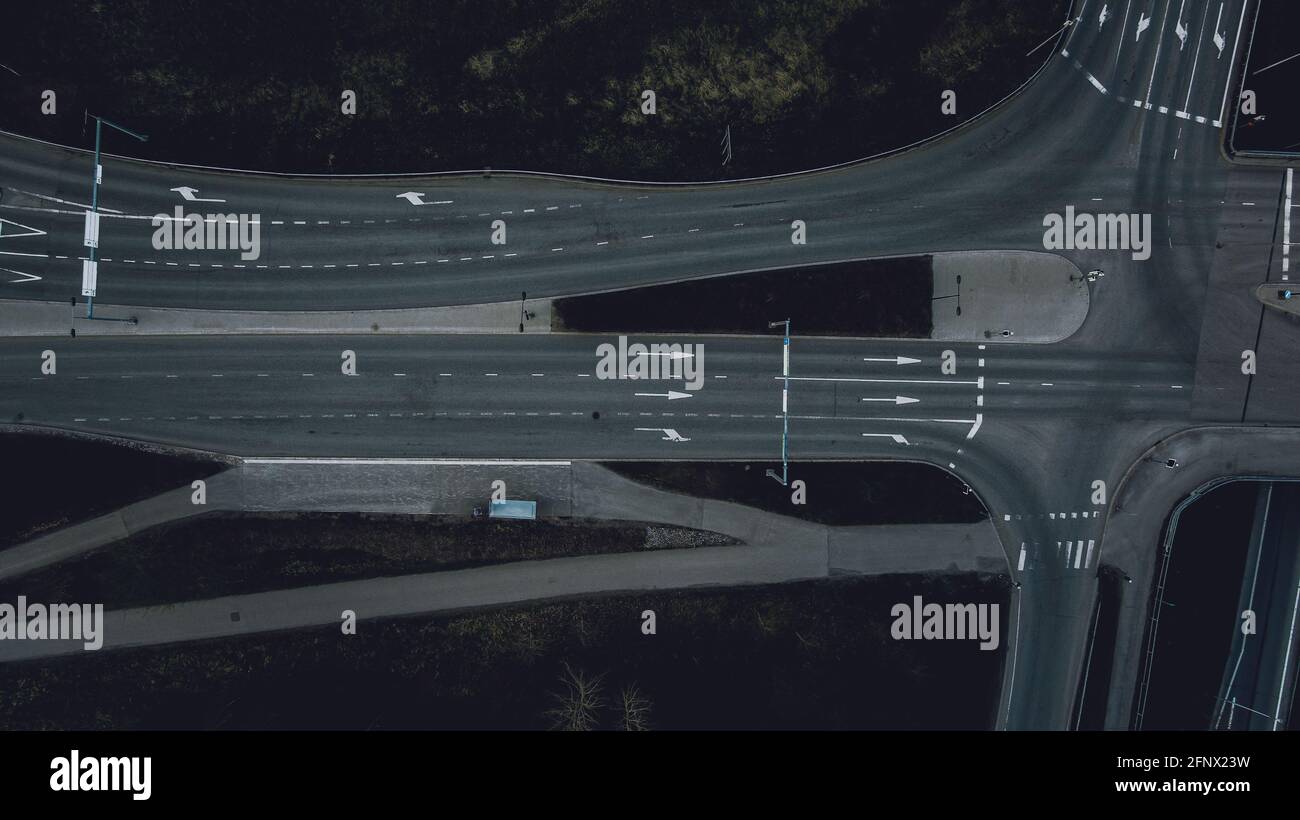 Aerial view of a junction with road markings at night Stock Photo - Alamy