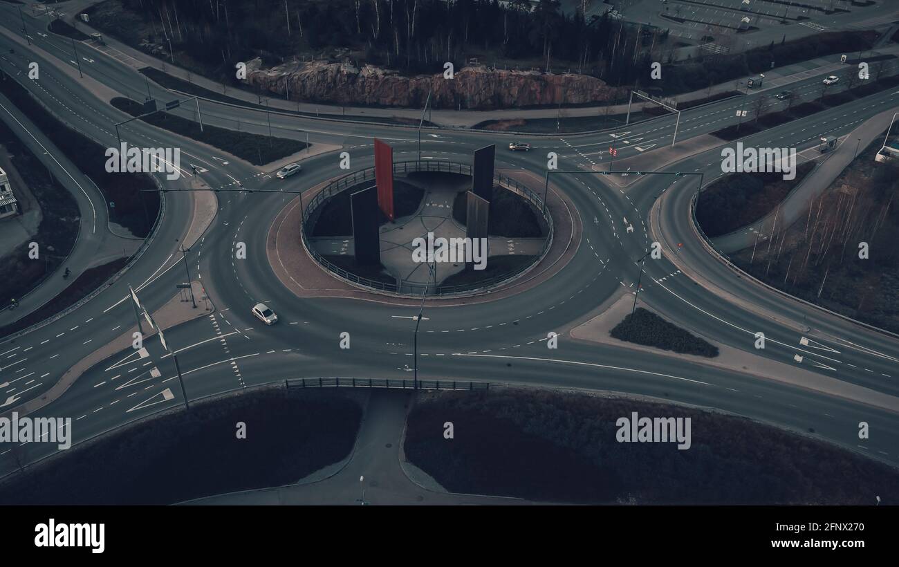 Aerial view of a roundabout with road markings at night. Elevated road ...