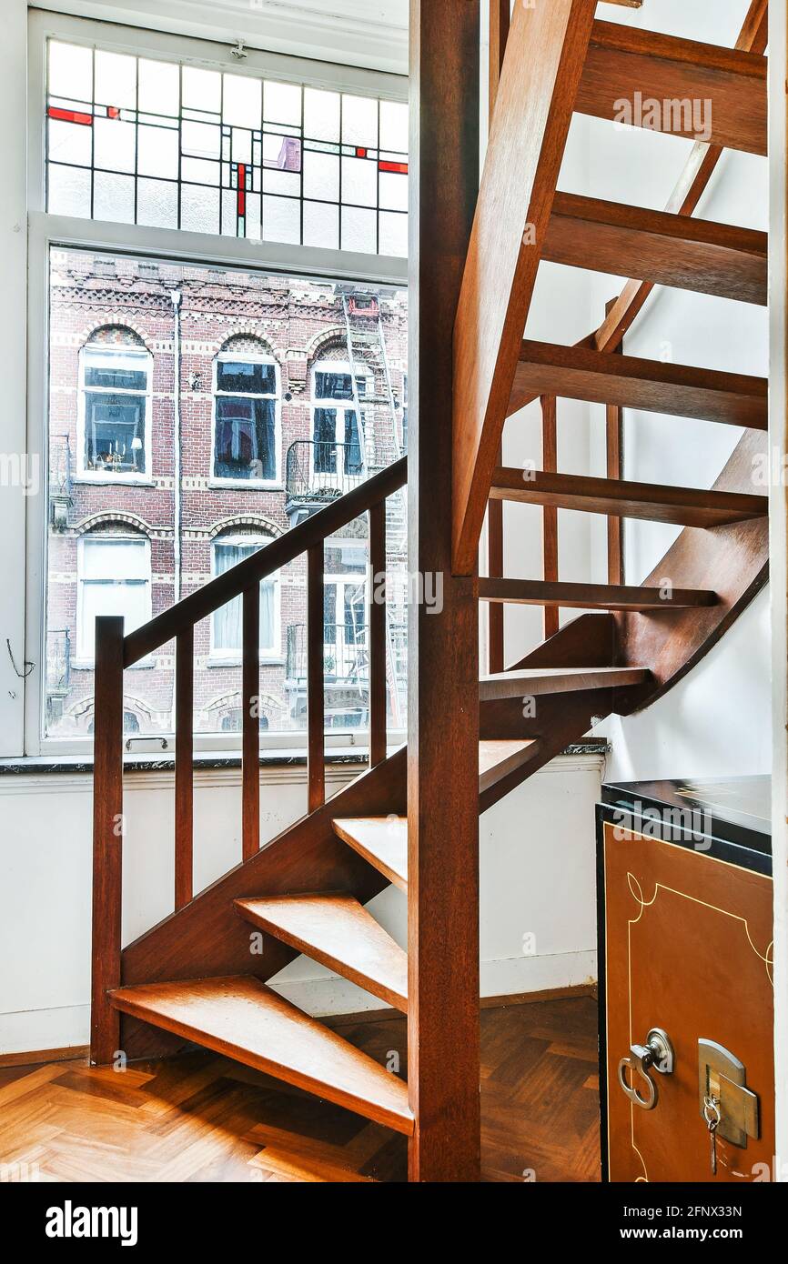Elegant spiral wooden staircase connecting levels of residential ...