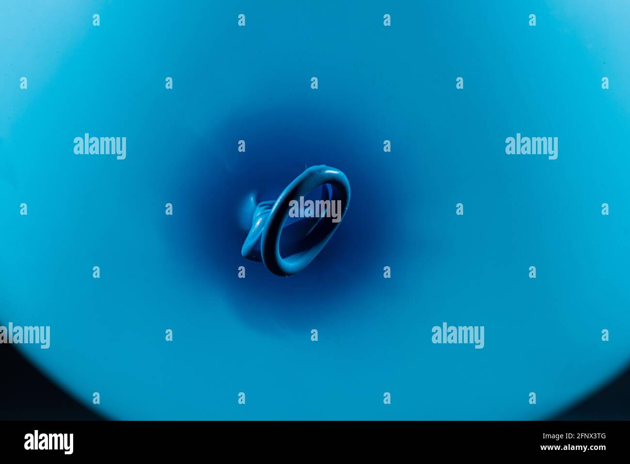 Neck, knot and lip of an inflated blue balloon Stock Photo - Alamy