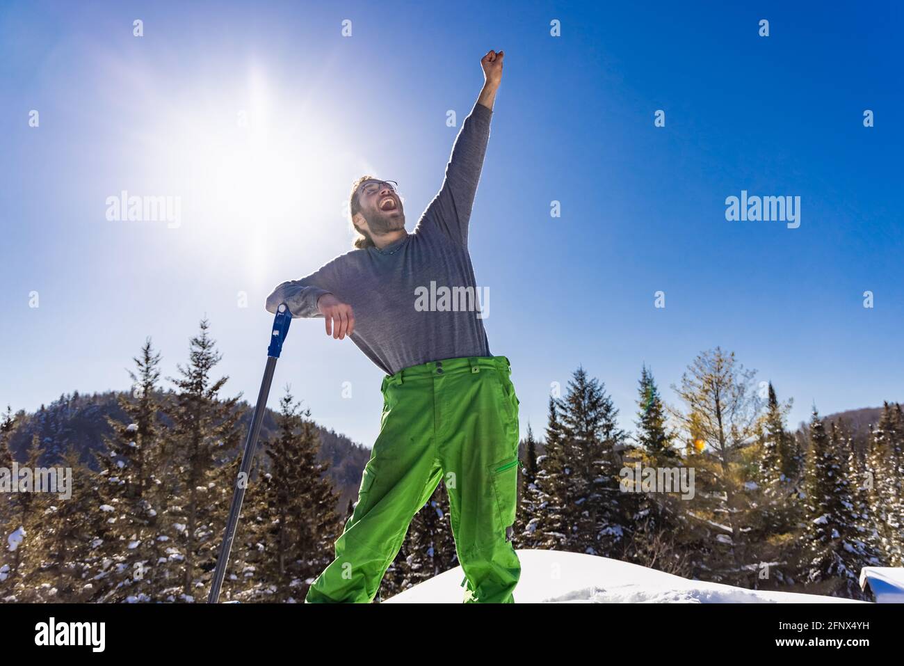 Iconic, superman pose portrait of a smiling man leaning on the handle ...