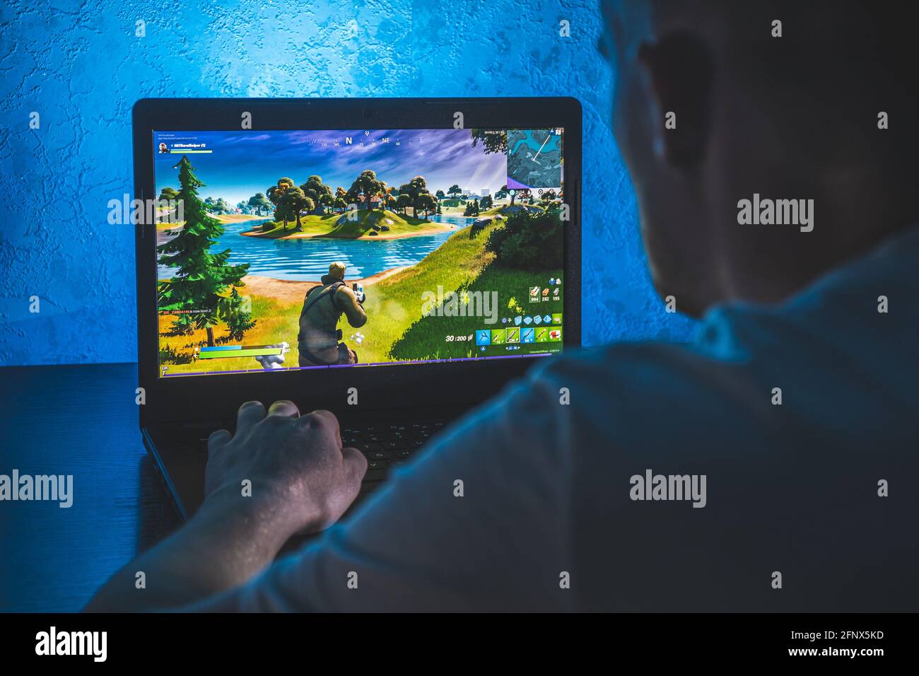 Person playing fortnite video game on computer Stock Photo - Alamy