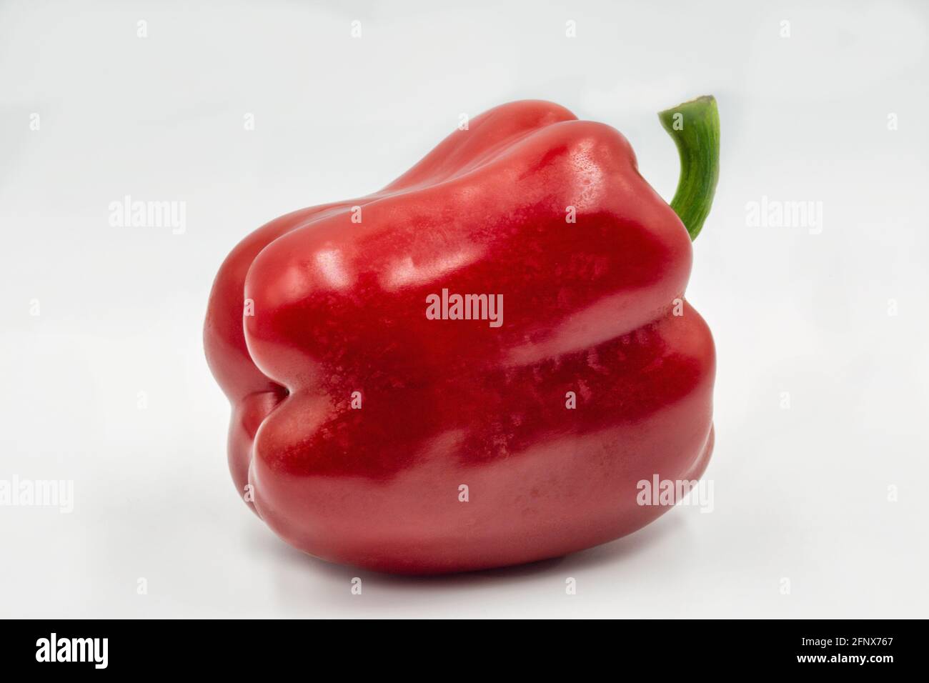 Fresh red pepper closeup against white background Stock Photo - Alamy