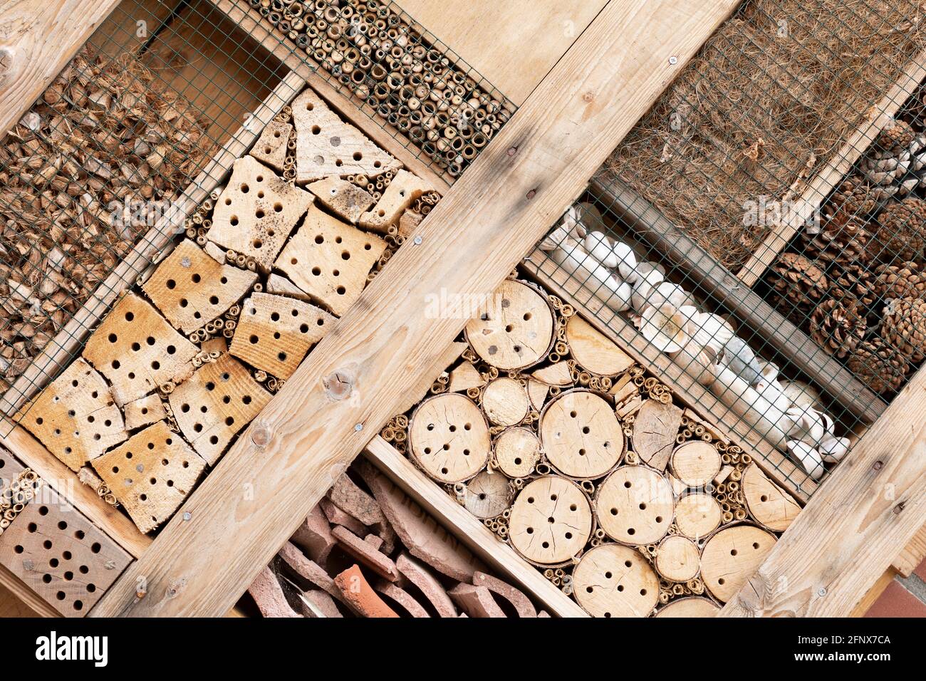 Detail of an insect hotel made of natural materials like wood, branches ...