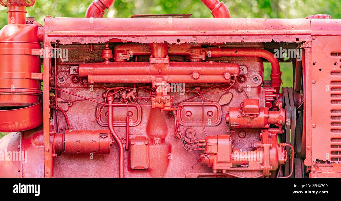 a bright red farm tractor engine Stock Photo - Alamy