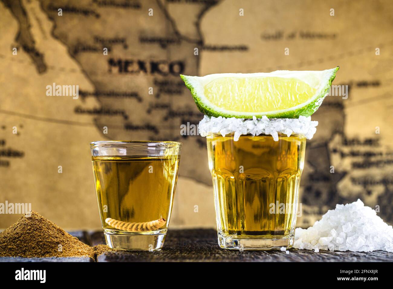 typical mexican drinks, Mezcal with salt, pepper and larva next to ...