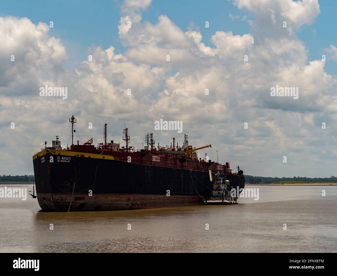 Oceanic ship and local boat on the Amazon River over 3,000 km from the ...