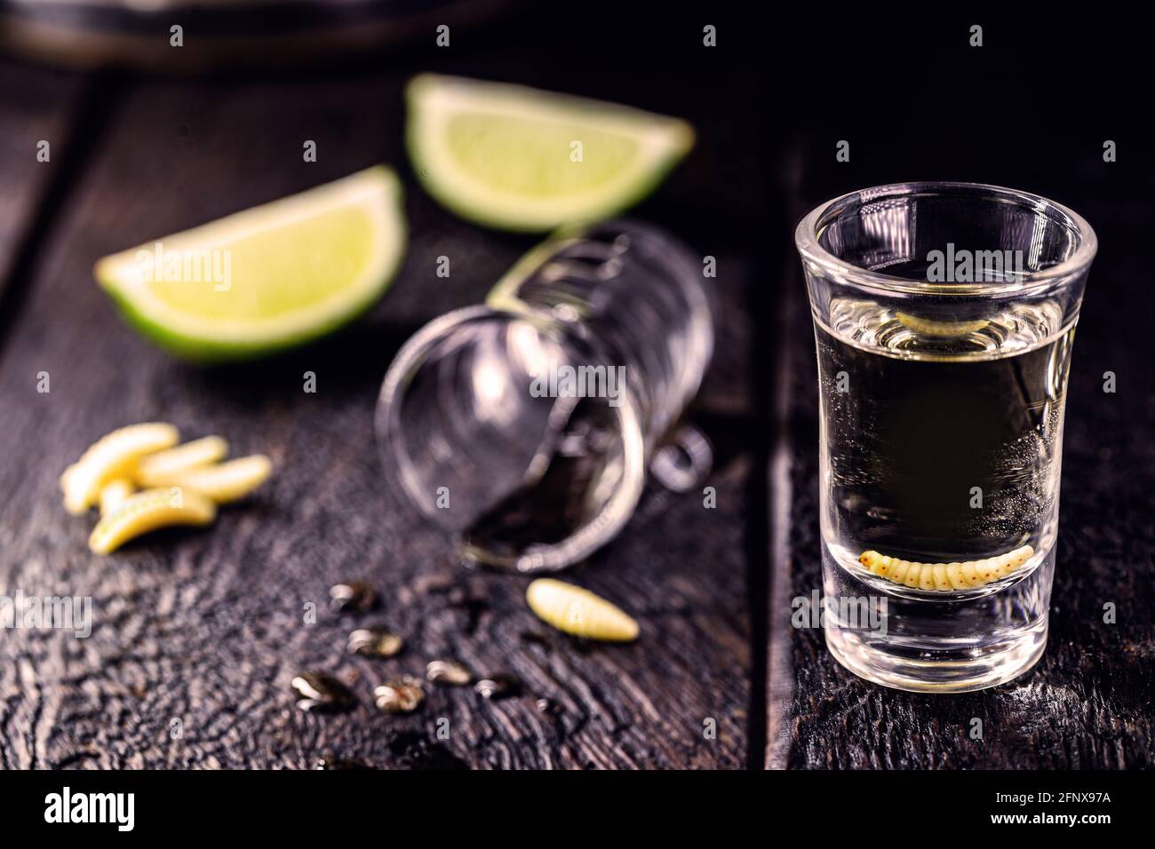 several glasses with mezcal (or mescal) is commonly known as "tequila ...