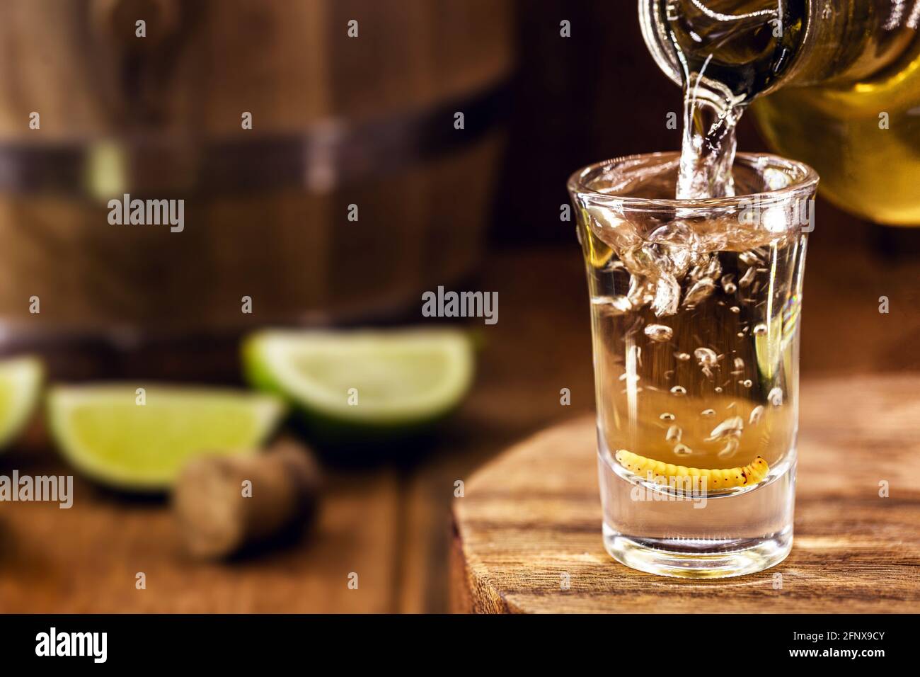 typical mexican drink bottle filling a glass of mezcal (or mescal), a ...