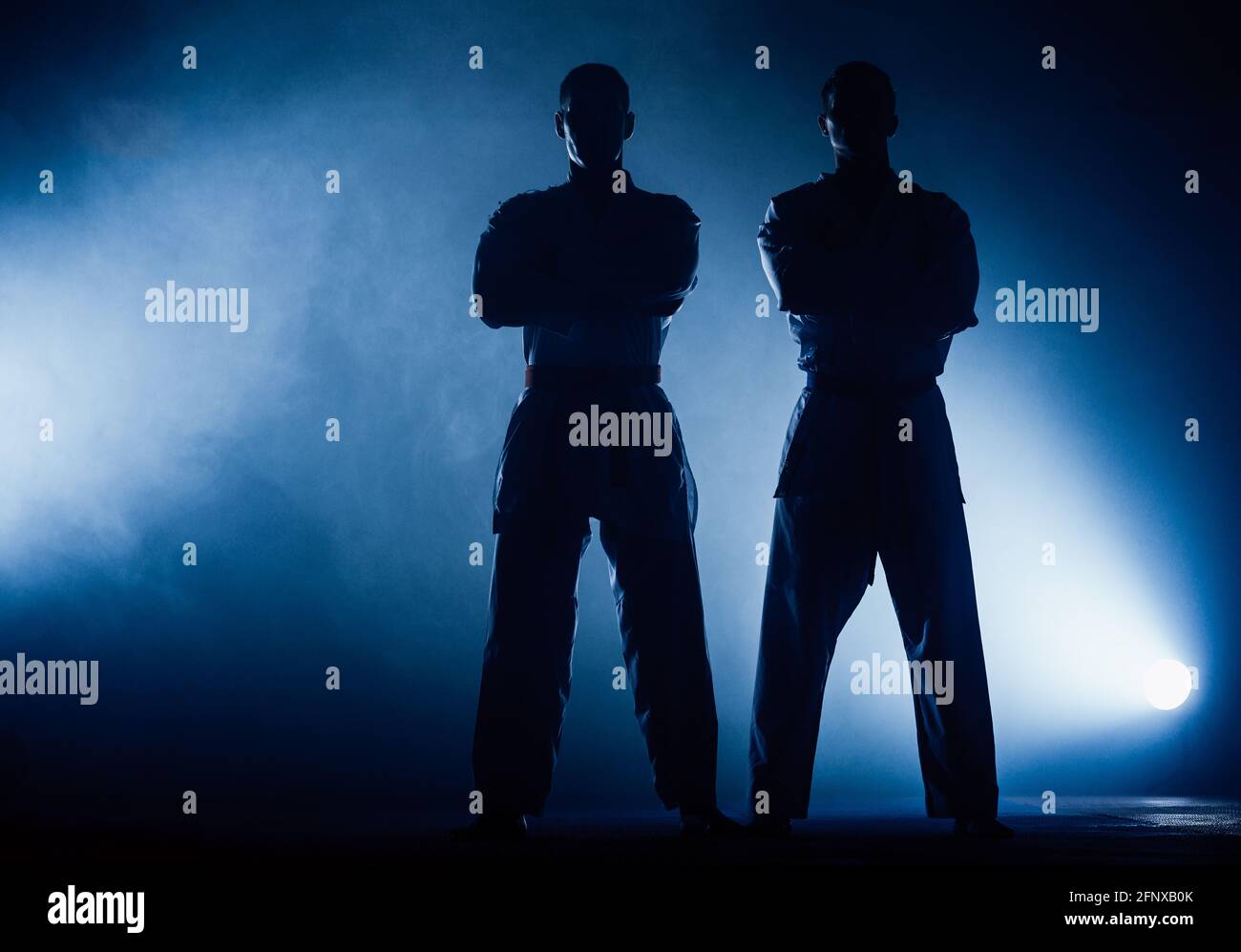 Strong fit athlete, karate men or fighters in white kimono, suit, with ...