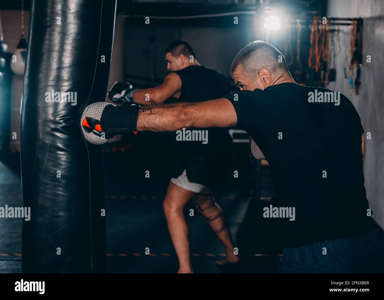 Concept of a healthy lifestyle.Young athlete fighter practicing kicks ...