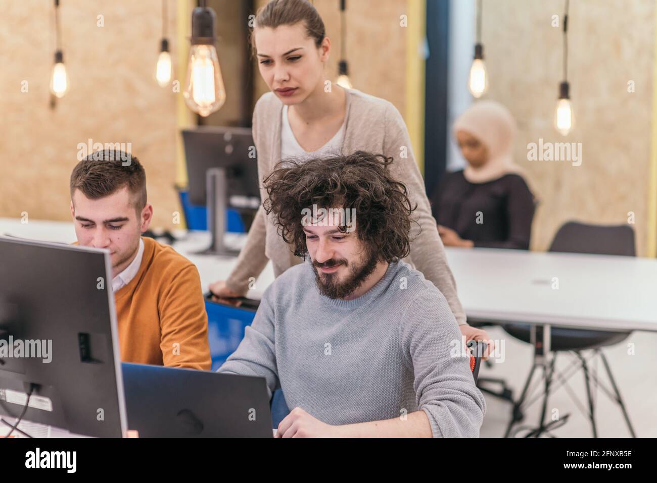 Group of coworkers, colleagues having fun at the office while chatting ...