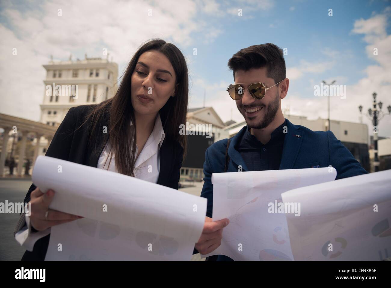 Business partners are laughing and smiling about the plan for their ...