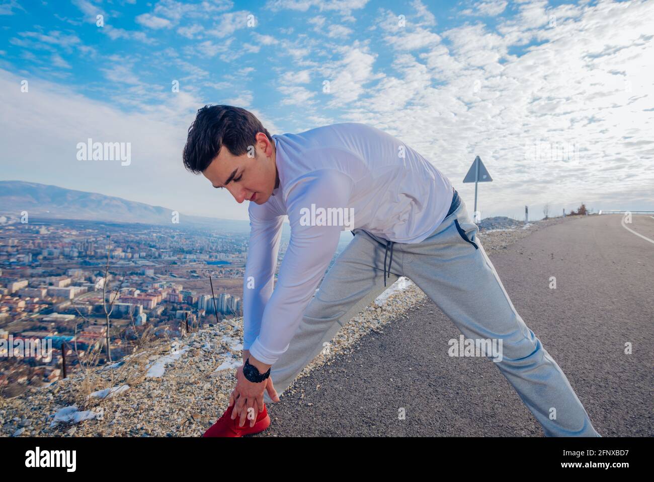 Fit male stretching and performing his morning routines while wearing a ...