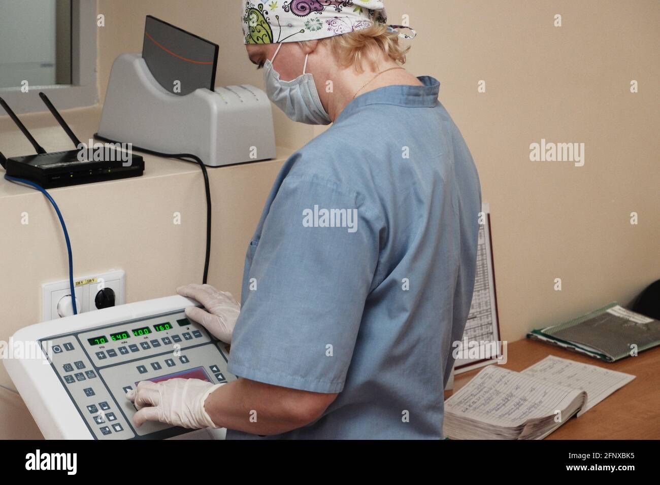 A woman radiologist at the X-ray apparatus is conducting diagnostic ...