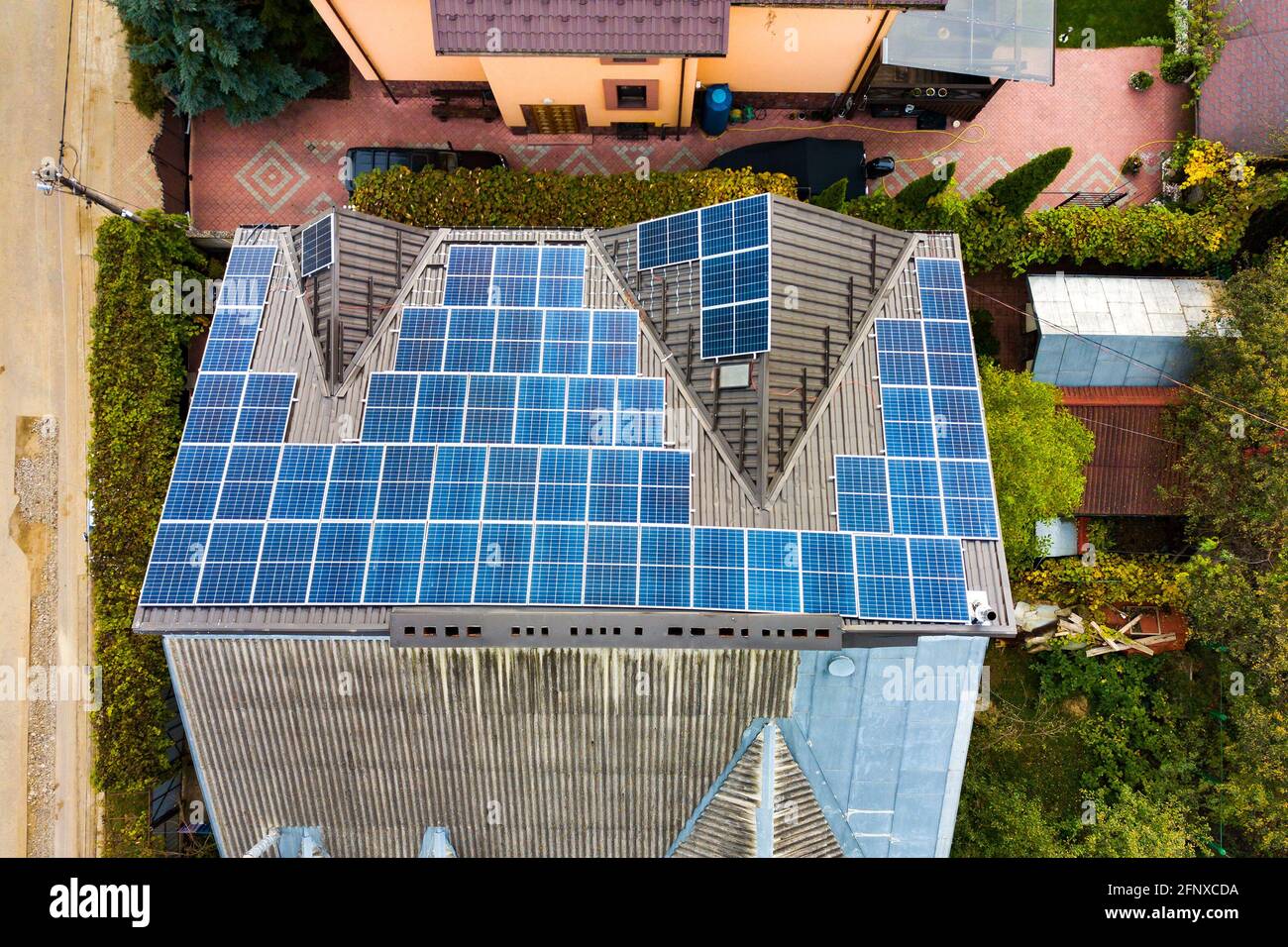 Aerial view of a private house with solar photovoltaic panels for ...