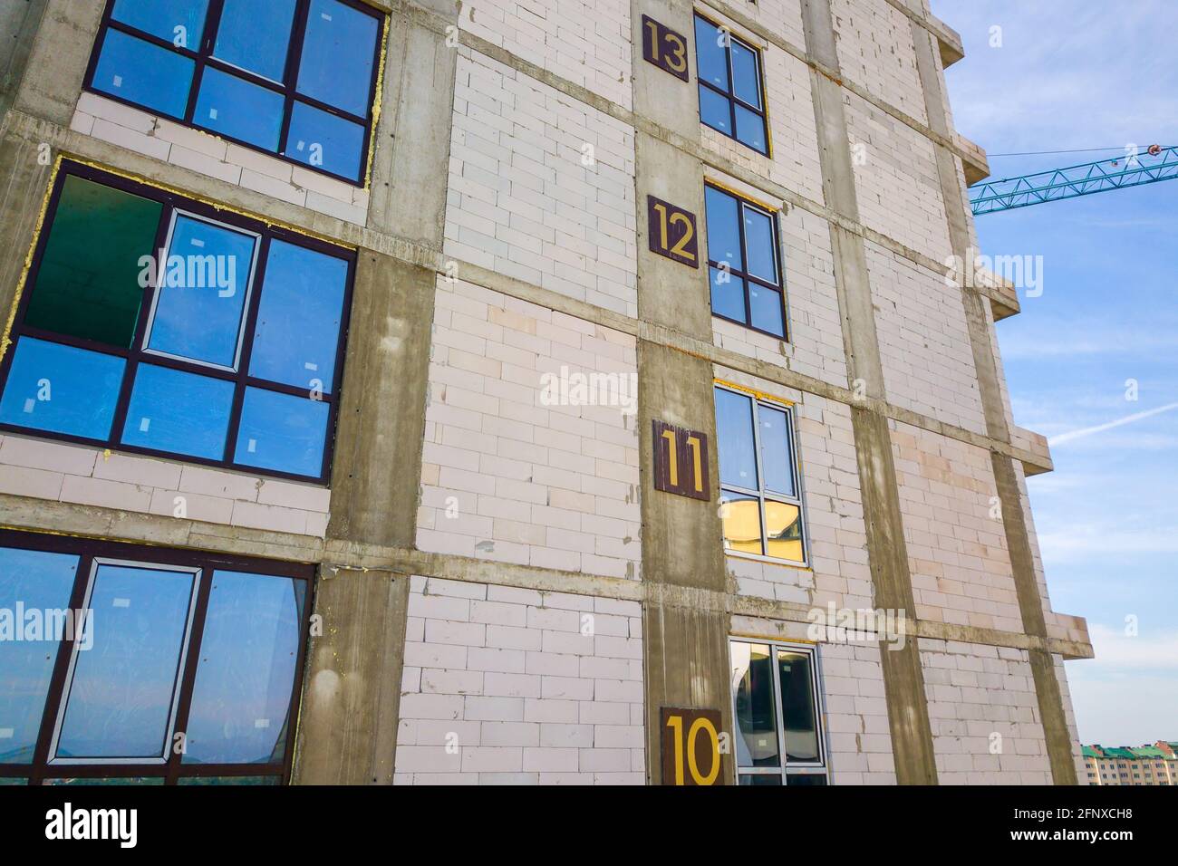 Aerial view of high residential apartment building with storey numbers ...
