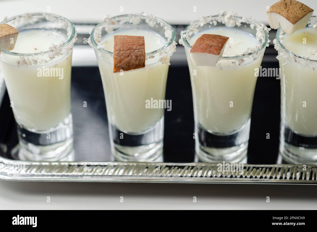 Coconut cocktail in drink shot glass based on the rum decorated with ...