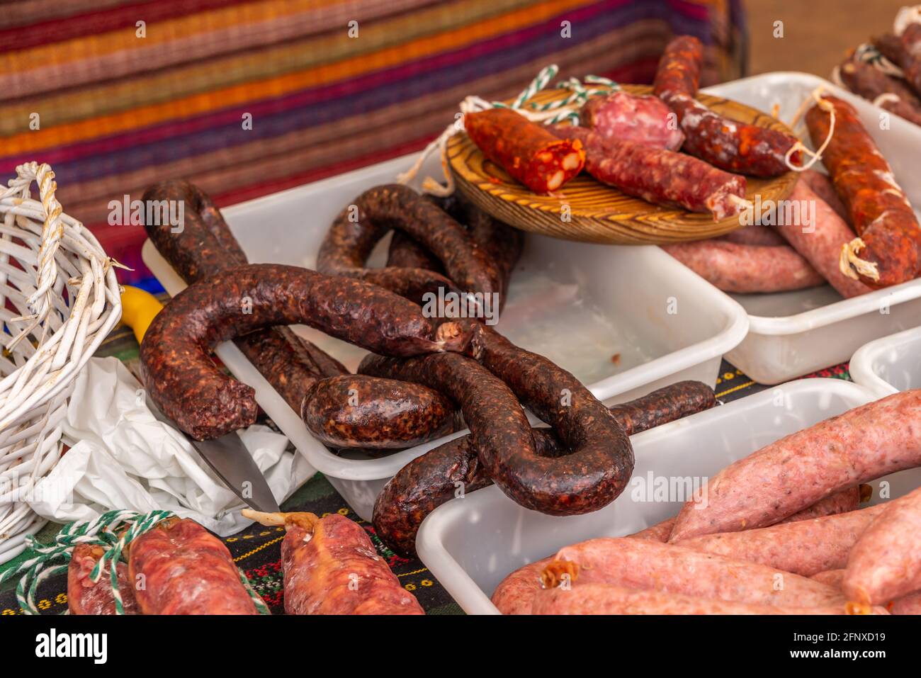 Typical Spanish sausages lying on a village stall at the food market ...
