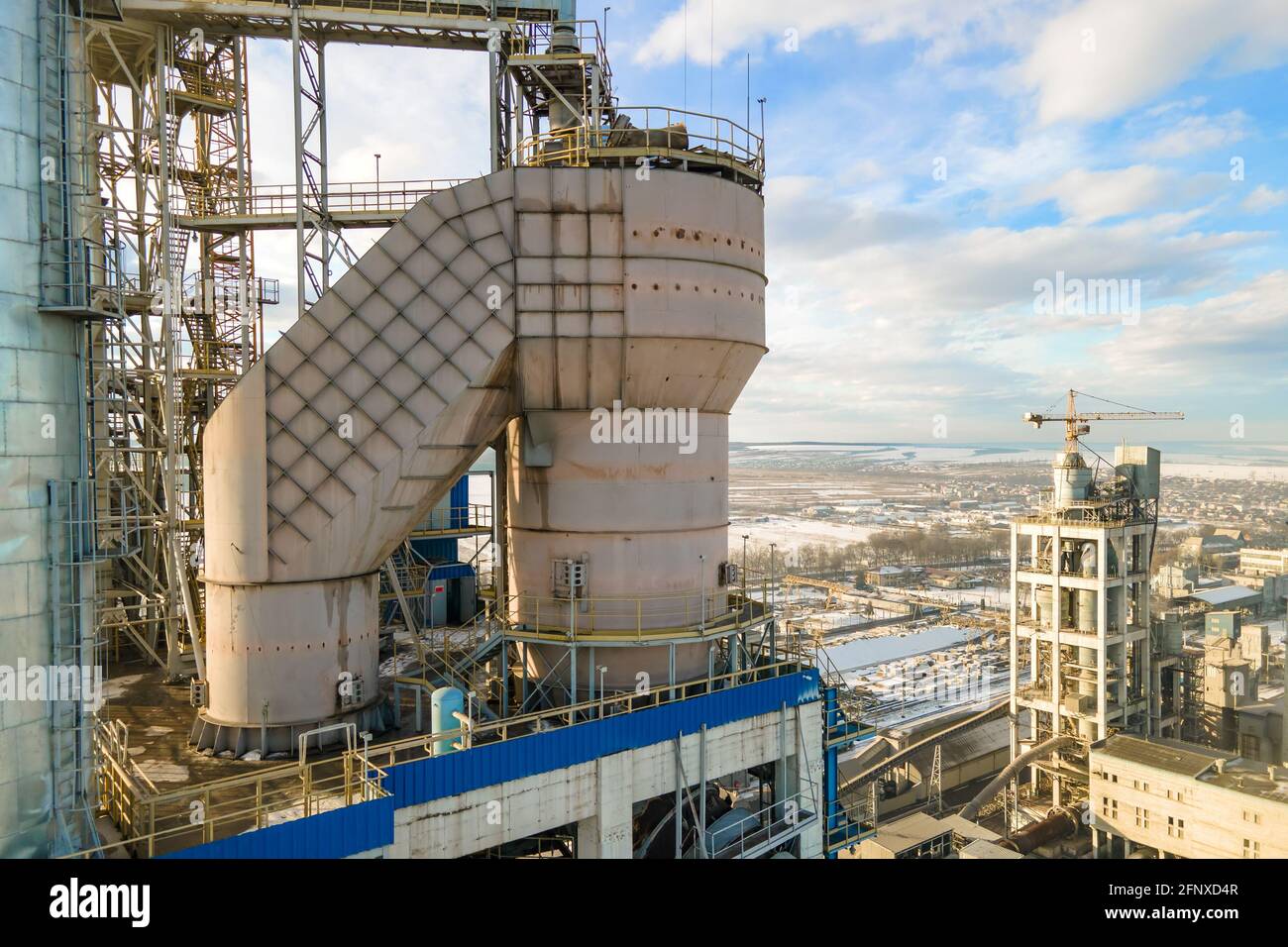 Aerial view of cement plant with high factory structure and tower crane ...