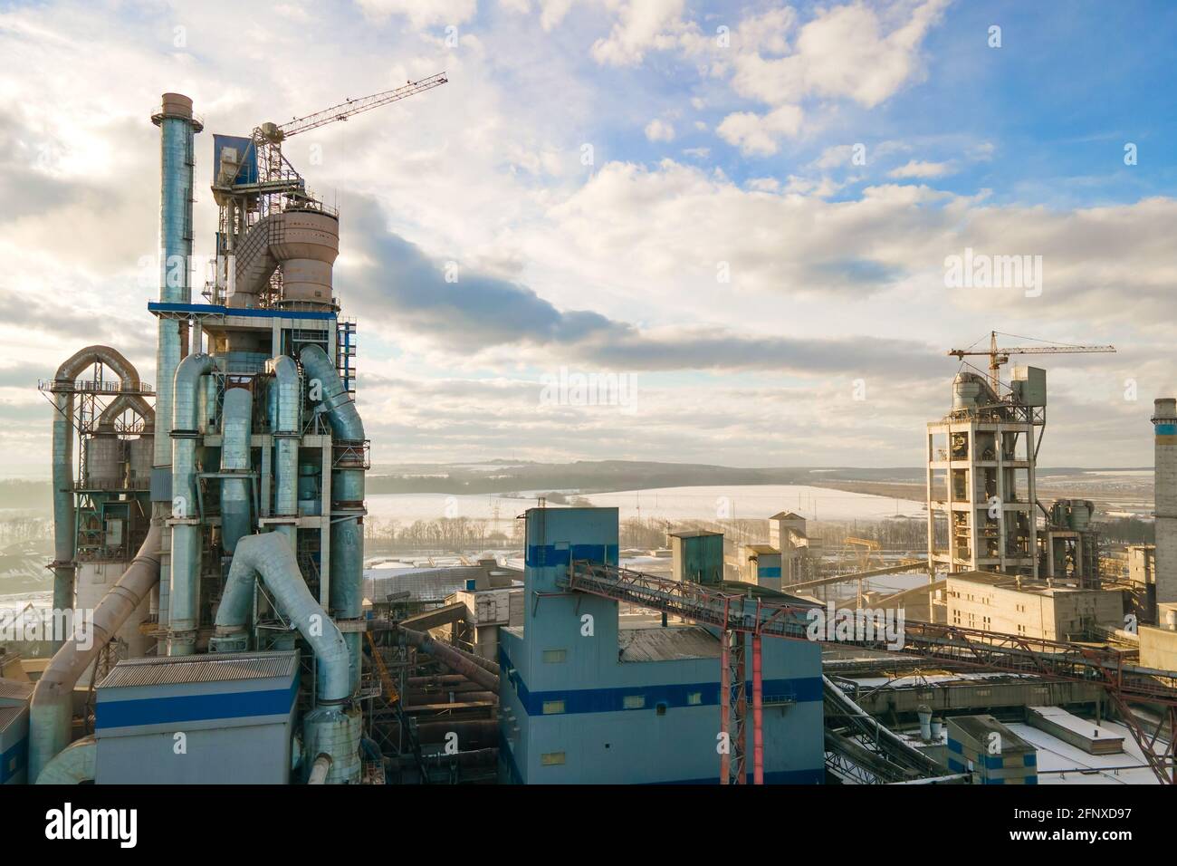 Aerial view of cement plant with high factory structure and tower crane ...
