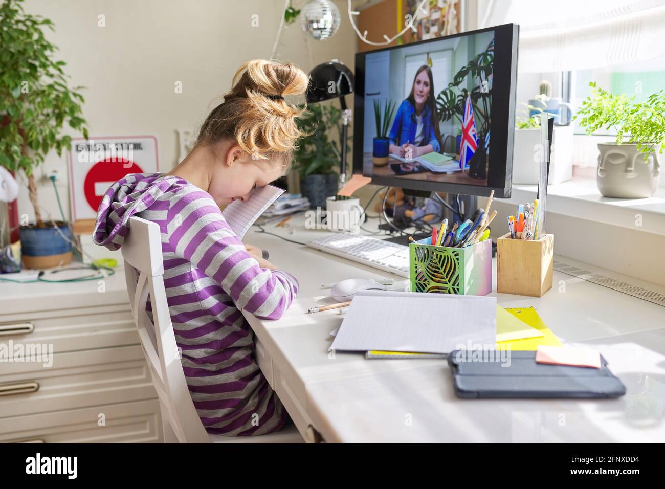 Girl child at home looking at computer monitor, talking learning ...