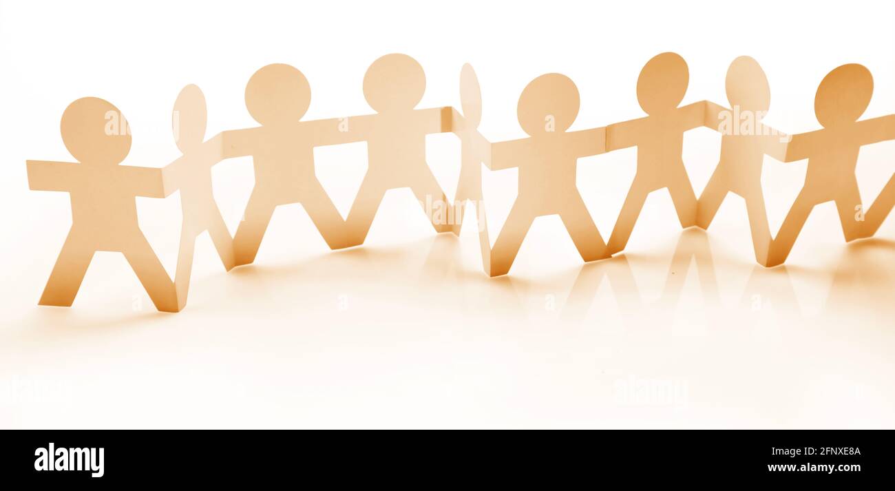 Paper chain team holding hands. Teamwork. Partnership Stock Photo - Alamy
