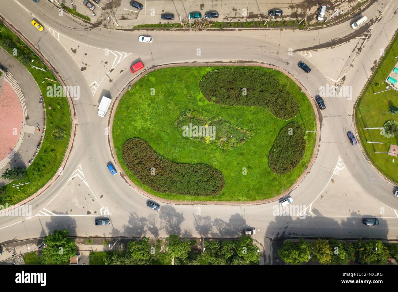 Top down aerial view of busy street roundabout intersection with moving cars traffic Stock Photo ...
