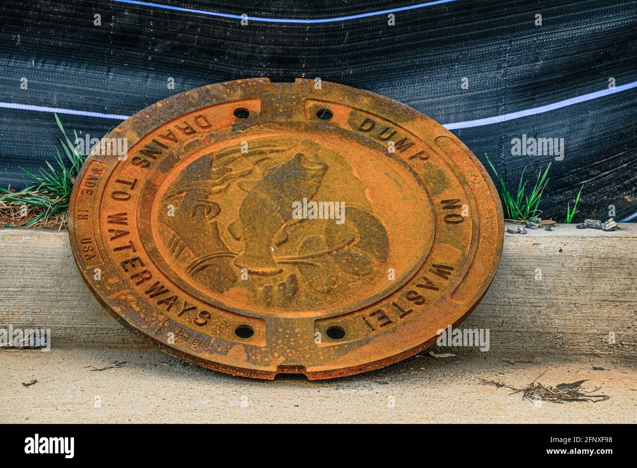 Rusty Manhole Cover in New Construction Stock Photo - Alamy