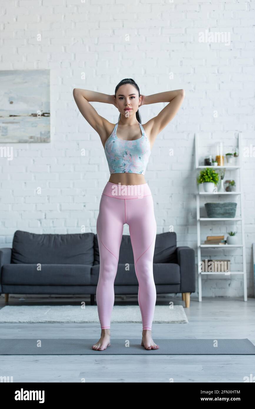 Young woman standing behind couch hi-res stock photography and images ...