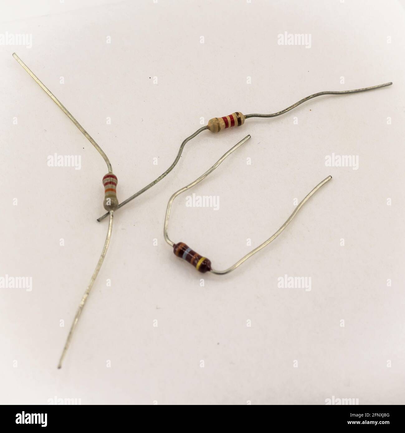 miniature resistors on white background. Passive two terminal ...