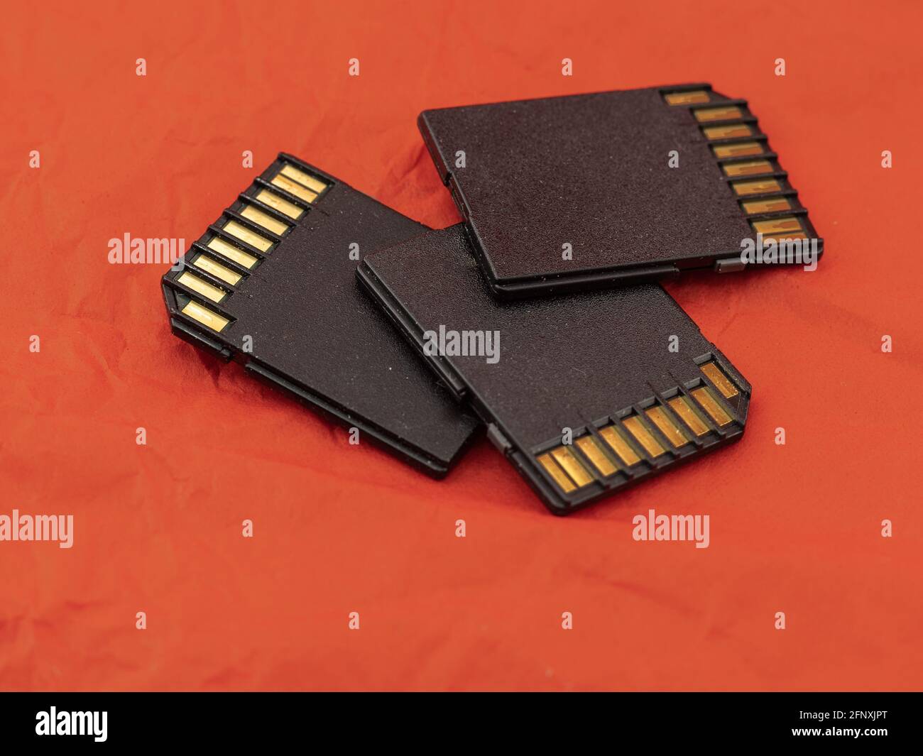 sd cards scattered on red background Stock Photo - Alamy