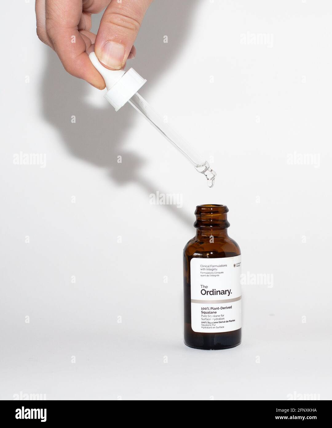 Opened bottle of The Ordinary Squalane on white background with the ...