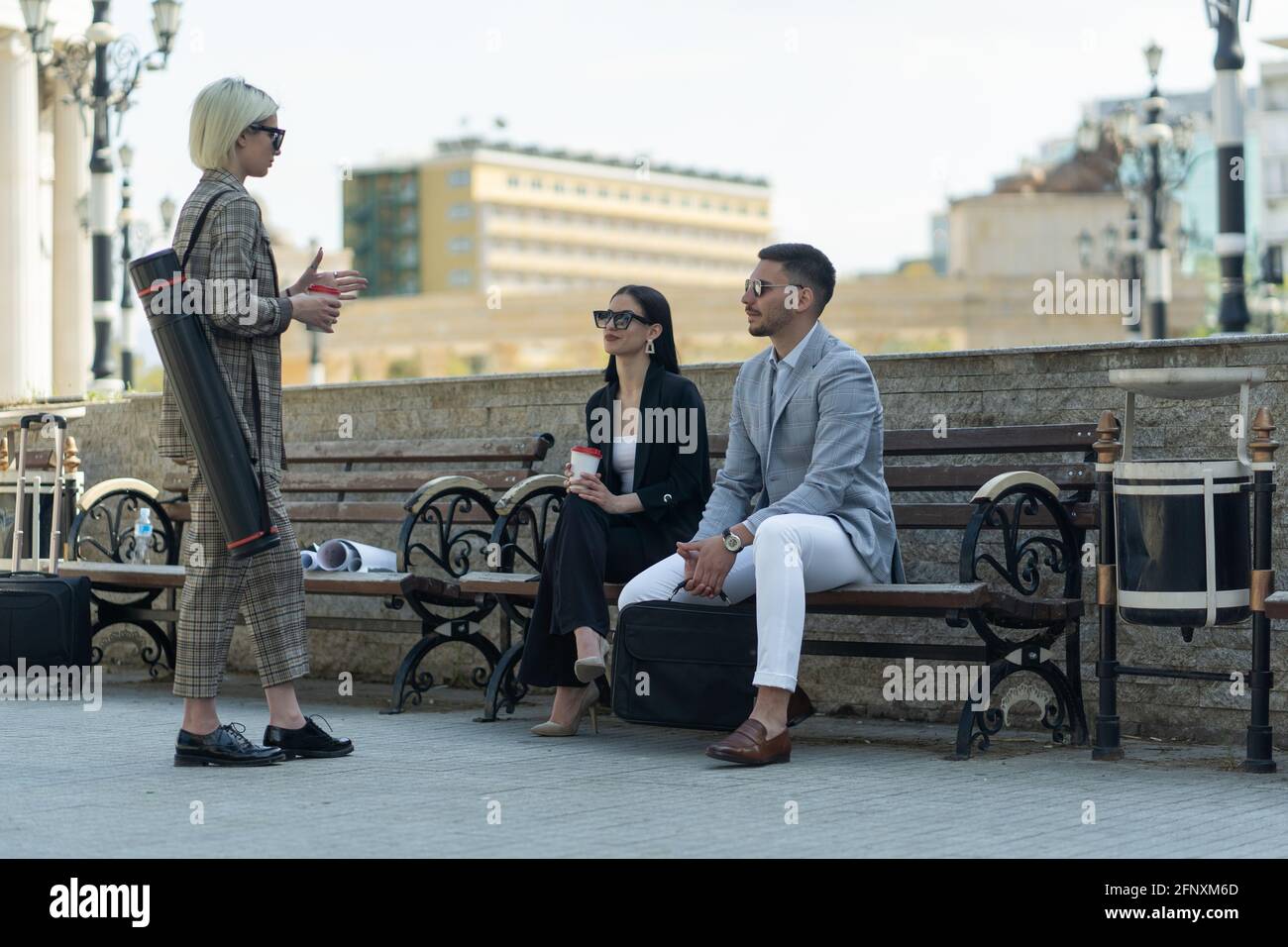 Three business people are talking abou the plan for their business ...